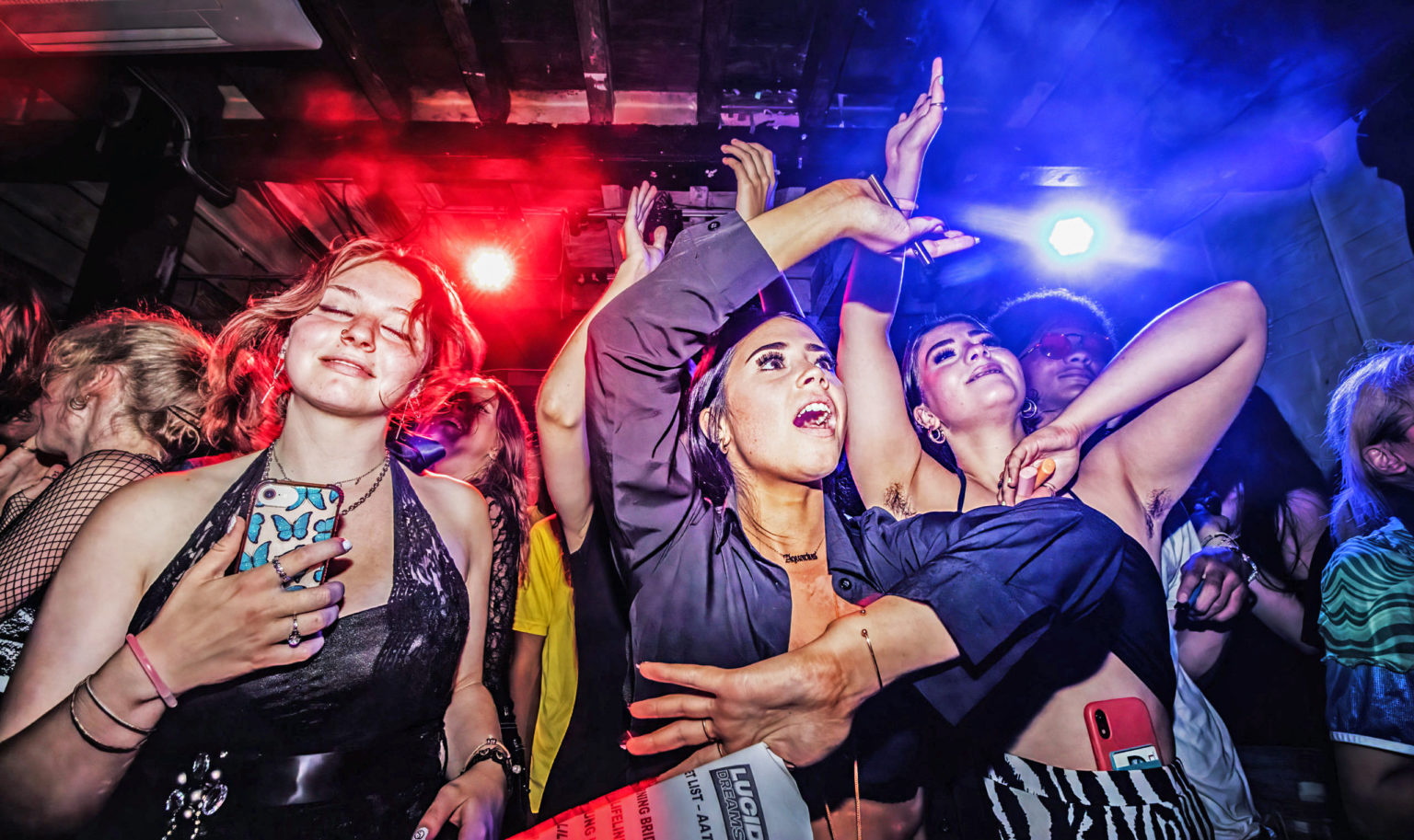 Revelers jump around in the mosh pit during a night out at - UnHerd